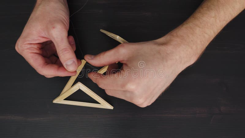Close-up of Hands Threading Needle with Thread through Ice Cream Stick ...