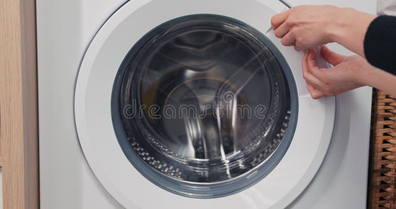 Close-up of Hands Trying To Open the Door of the Washing Machine, Which ...