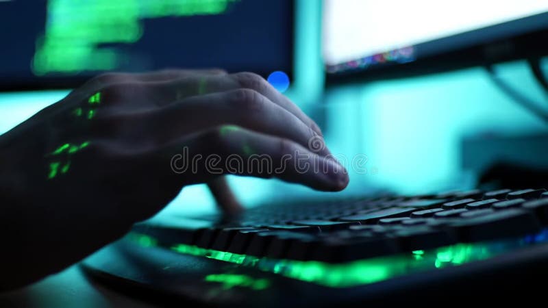 Night Programmer Coding On Illuminated Keyboard And Monitors Displaying