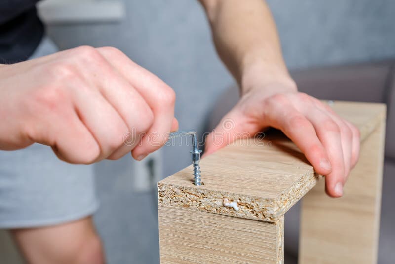 Anonymous Craftsman Using Screwdriver For Work With Wooden Furniture