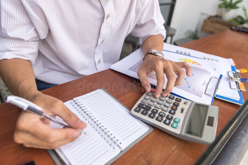 Close-up of Hands Using Calculator and Writing Note Stock Photo - Image ...