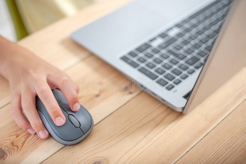 Close-up of Hands Using a Mouse Next To a Laptop Keyboard. Stock Image ...