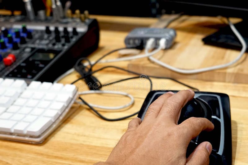 Close Up of a Hands Using a Mouse on Wooden Desk with Sound Mixer in ...