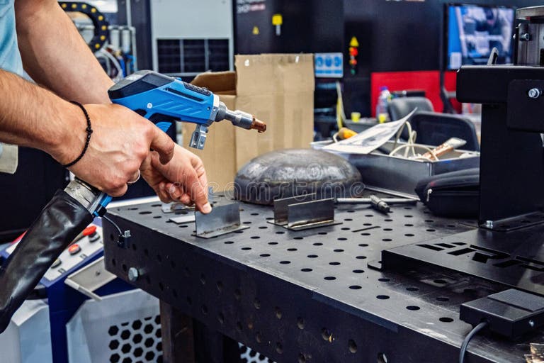 Close-up of Hands Using a Welding Tool on a Perforated Metal ...