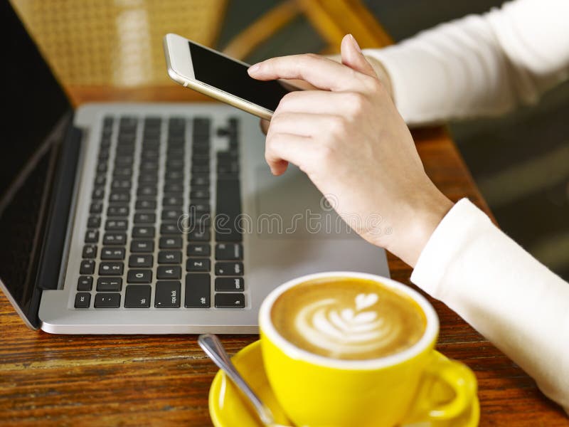 Woman Using Cellphone and Laptop while Drinking Coffee Stock Photo ...