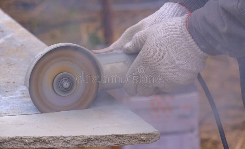 Close-up of the Hands of a Worker Sawing an Asbestos Slab on a Grinding ...