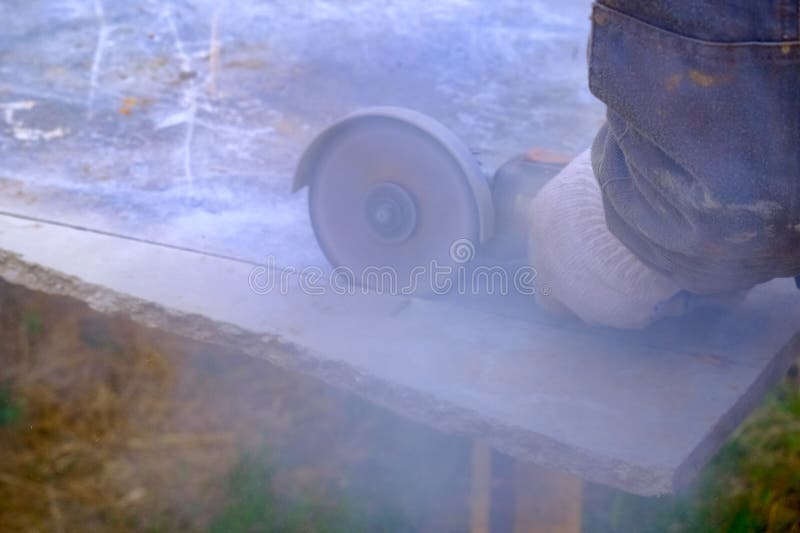 Close-up of the Hands of a Worker Sawing an Asbestos Slab on a Grinding ...
