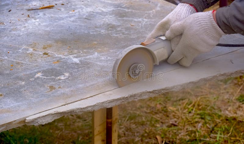 Close-up of the Hands of a Worker Sawing an Asbestos Slab on a Grinding ...