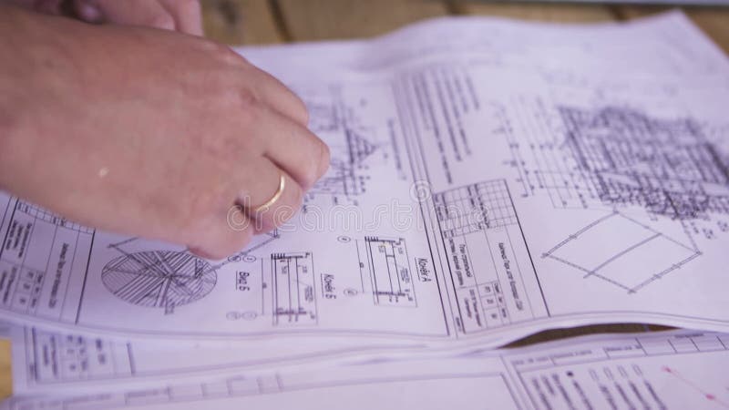 Close Up for Hands of Workers at a Factory Looking through Technical ...
