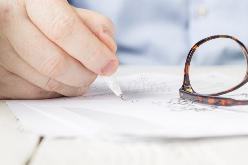 Close Up of Hands Writing on Wooden Desktop with Various Items Stock ...