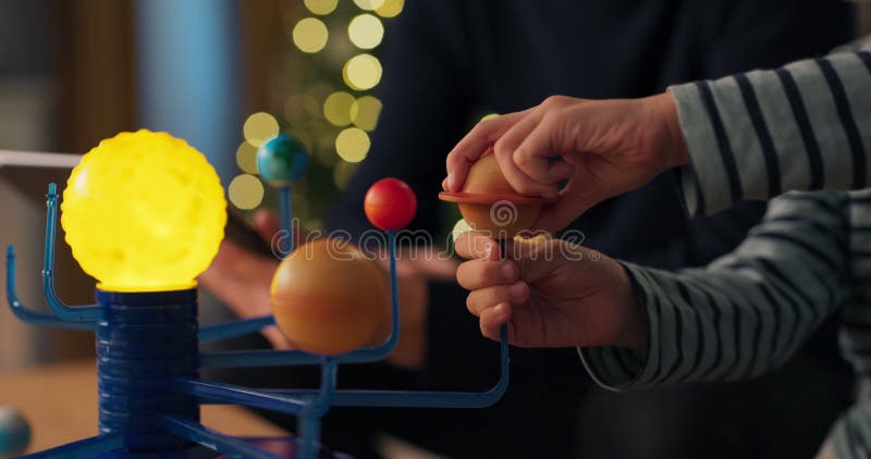 Close-up of Father and Son Watching the Rotation of the Planets in ...
