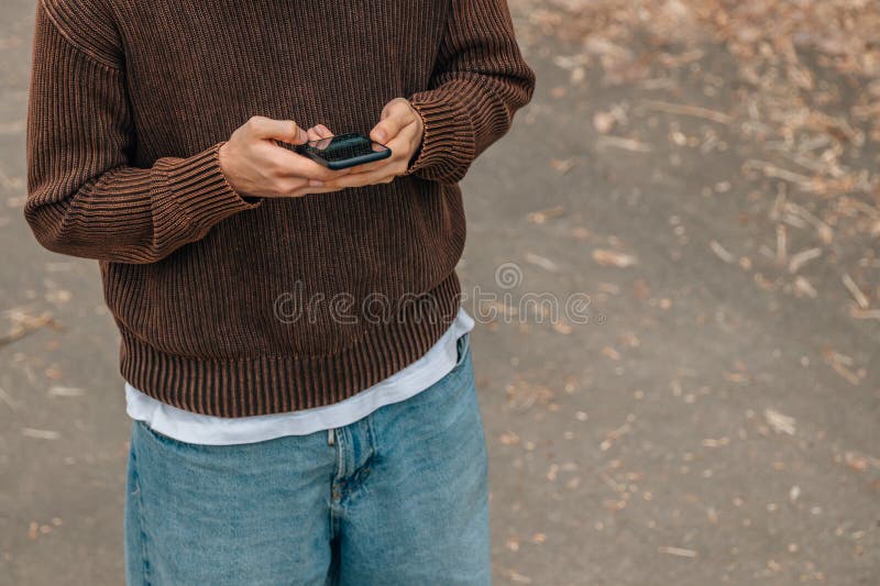 Hands of Young Man with Mobile Phone on the Street Stock Photo - Image ...