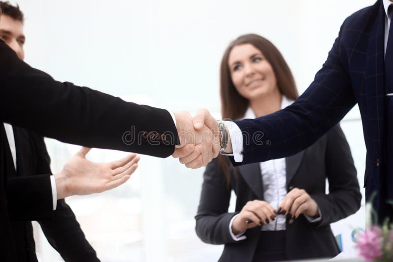 Close Up.handshake of Business Partners in the Background of the Office ... Close Up.handshake of Business Partners in the Background of the Office ...