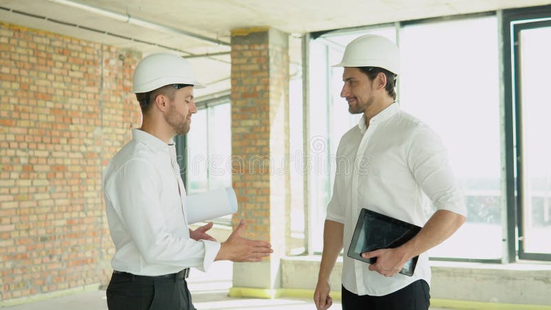 Friendly Handshake of Two Builders at a Construction Site. Close Up of Handshake in Construction ...