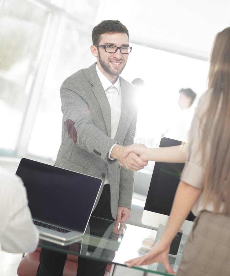 Close Up. the Handshake of Employee and Customer in a Modern Office ...