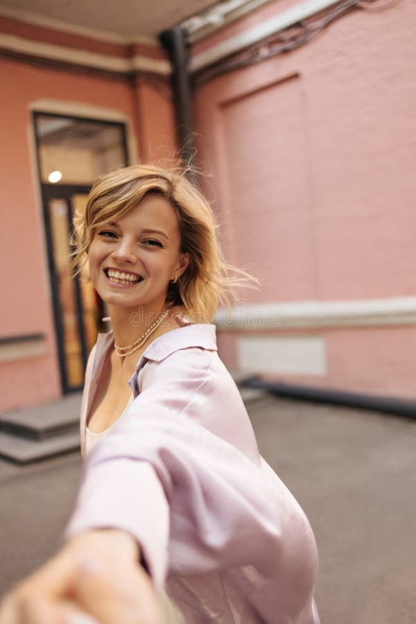 Close Up Of Happy Caucasian Young Blonde Woman Laughs And Stretches