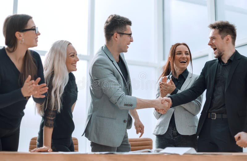 Close Up. Happy Employees Applaud and Shake Hands Stock Image - Image ...