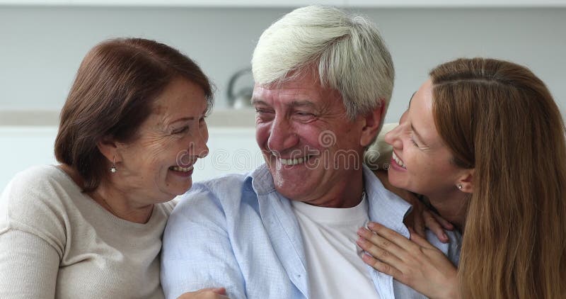 Closeup Happy Faces of Adult Daughter and Optimistic Older Parents ... Closeup Happy Faces of Adult Daughter and Optimistic Older Parents ...