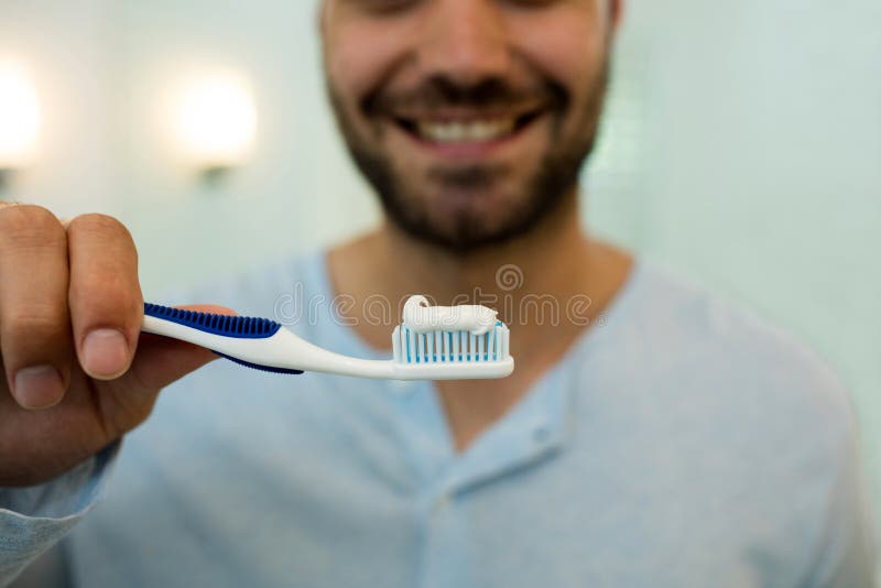 Close-up of Happy Young Man Holding Toothbrush with Toothpaste Stock ...