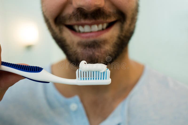 Close-up of Happy Young Man Holding Toothbrush with Toothpaste Stock ...