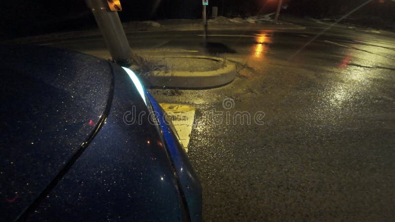 Close Up of a Headlight Signaling Left on a Blue Car Turning at an ...