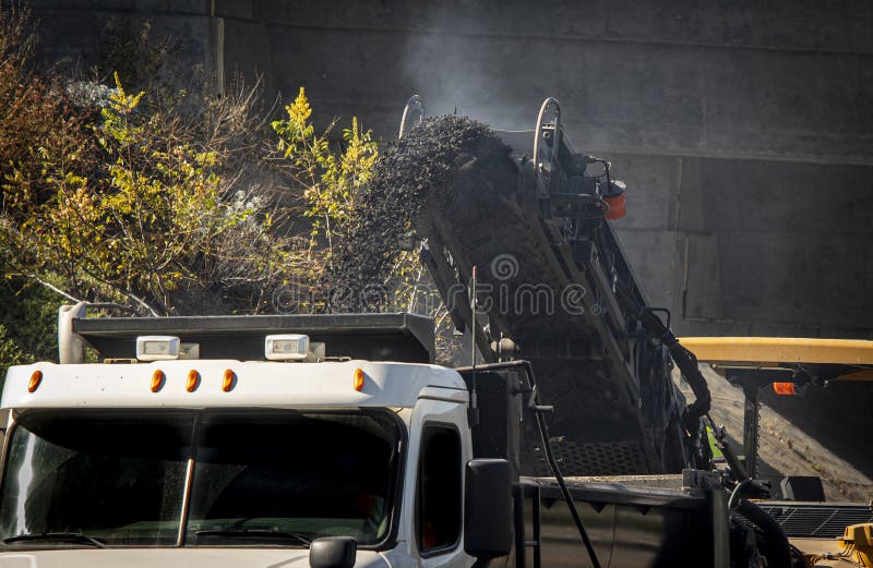 Close Up of Hot Steaming Asphalt Pouring of a Conveyor Belt of an ...