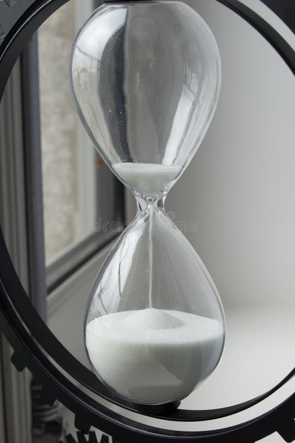Close Up of an Hourglass with Sand Flowing from the Upper Part Stock ...