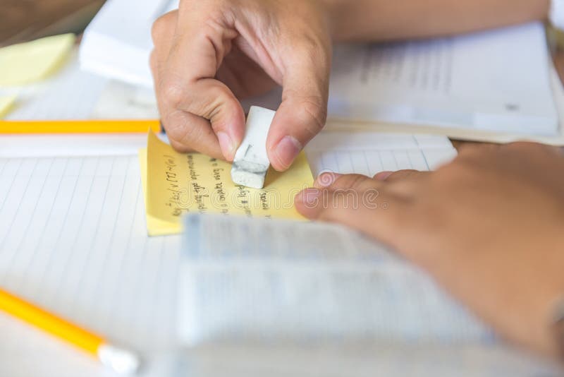 Close-up of Human Hand Erase Some Words on Sticky Note Stock Image ...