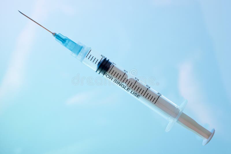 Hypodermic Syringe on a Blue Background Stock Photo - Image of ...