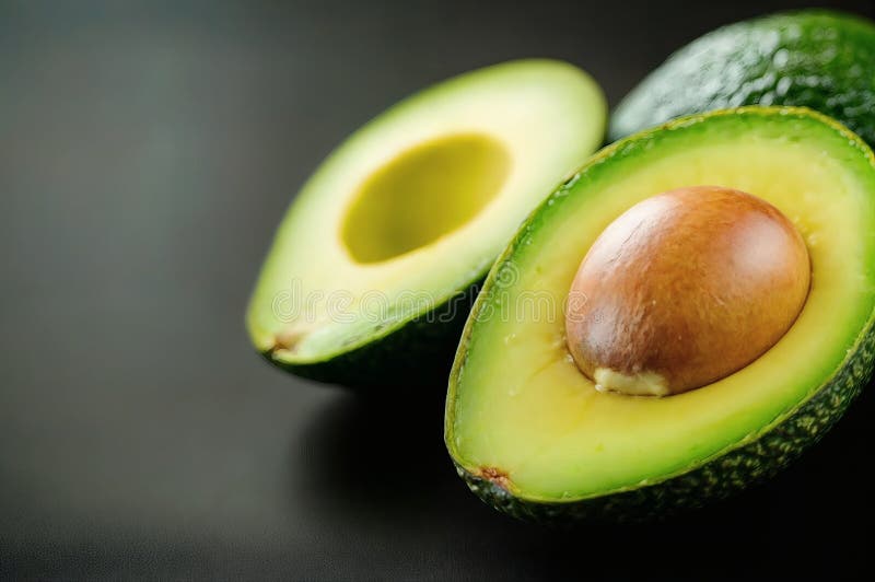 Close Up Image of Avocado Cut in Two and Another Whole Avocado with ...