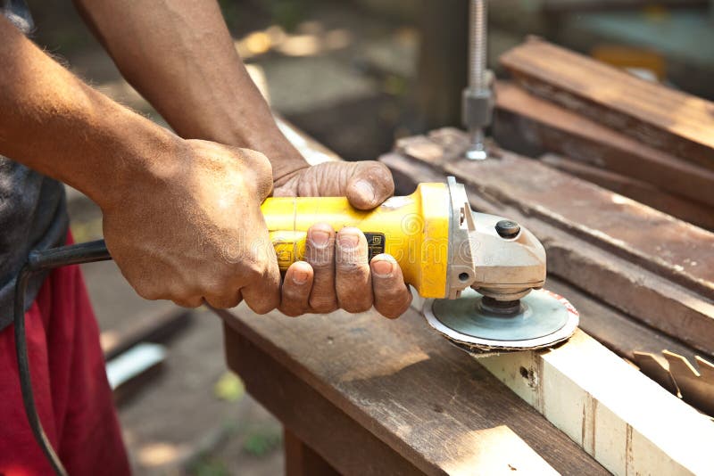 Hand holding wood grinder. stock photo. Image of construction - 29749820