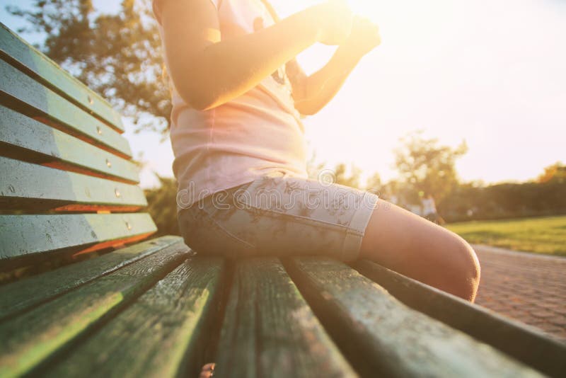 Close Up Image of Child Sitting on Bench during Sunset. Stock Photo ...