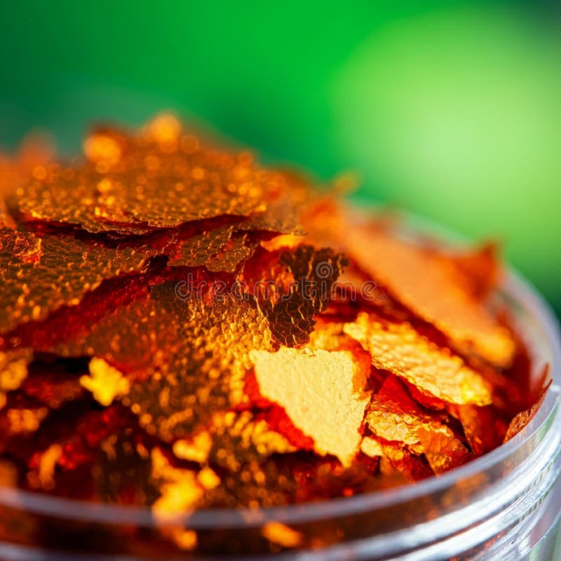 A Close-up Image of a Container Filled with Orange Metallic Flakes. the ...
