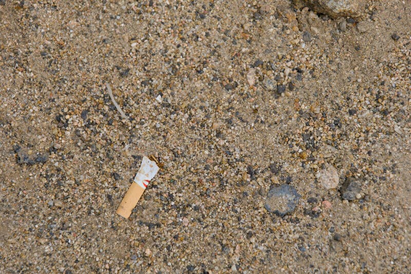 Cigarette on the Ground stock photo. Image of responsibility - 357960382