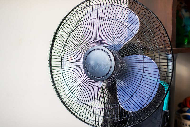 This is a Close Up Image of a Fan Set Against a Plain White Wall Stock ...