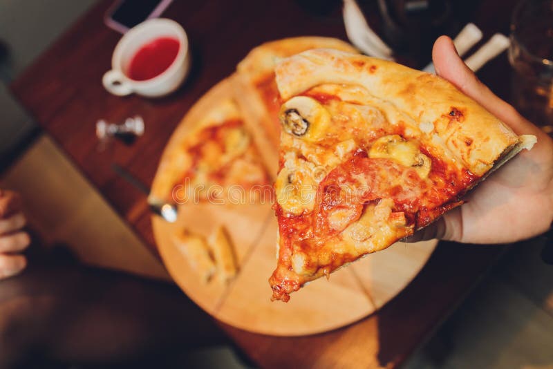 Close Up Image of a Female Hands Holding a Slice of Pizza. Stock Photo ...