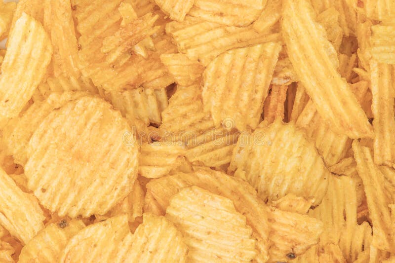 Close-up Image of Golden-yellow, Ridged Potato Chips on Blurred ...