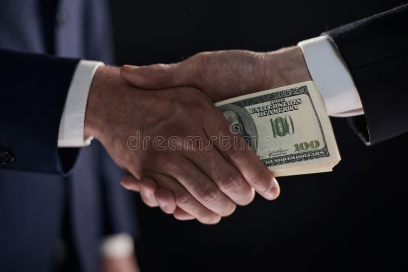 Handshake with the Transfer of Money on a Black Background Stock Image ...