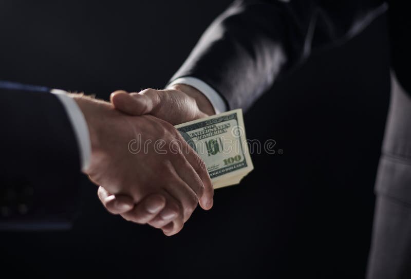 Handshake with the Transfer of Money on a Black Background Stock Image ...