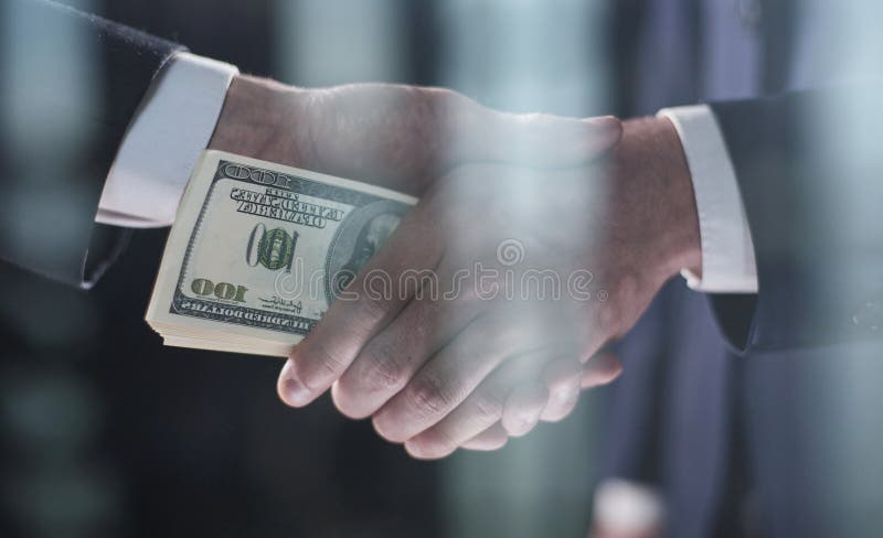Handshake with the Transfer of Money on a Black Background Stock Image ...