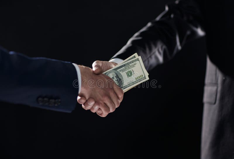 Handshake with the Transfer of Money on a Black Background Stock Image ...