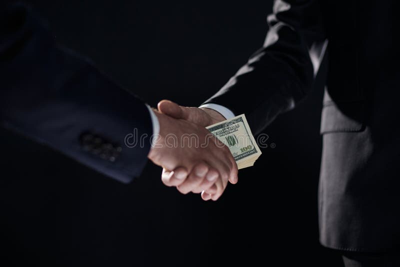 Handshake with the Transfer of Money on a Black Background Stock Image ...