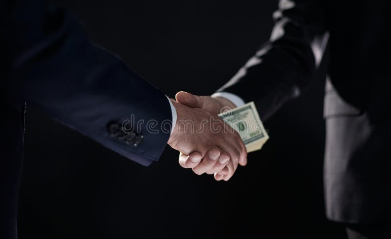 Handshake with the Transfer of Money on a Black Background Stock Image ...