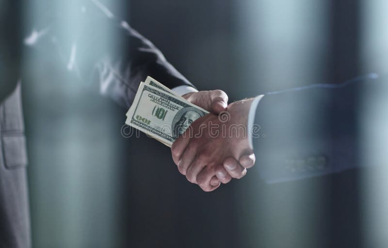 Handshake with the Transfer of Money on a Black Background Stock Image ...