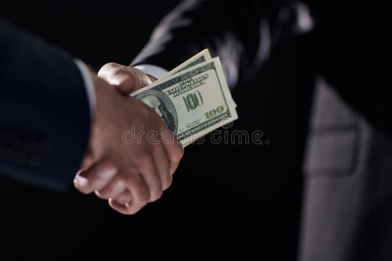 Handshake with the Transfer of Money on a Black Background Stock Image ...
