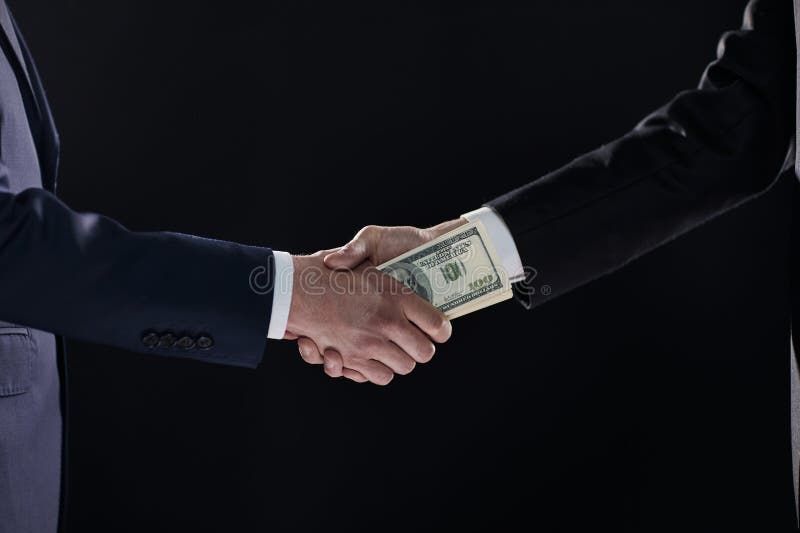 Handshake with the Transfer of Money on a Black Background Stock Image ...