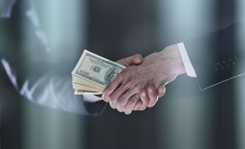 Handshake with the Transfer of Money on a Black Background Stock Photo ...
