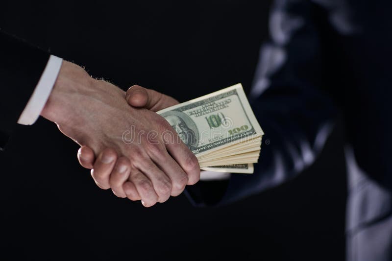 Handshake with the Transfer of Money on a Black Background Stock Image ...