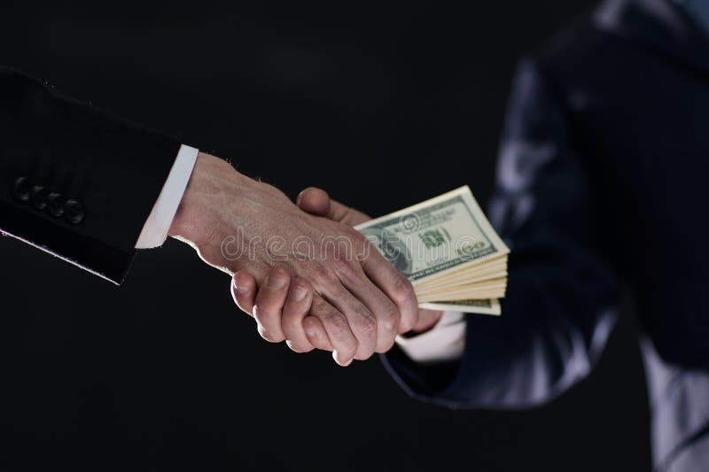 Handshake with the Transfer of Money on a Black Background Stock Image ...