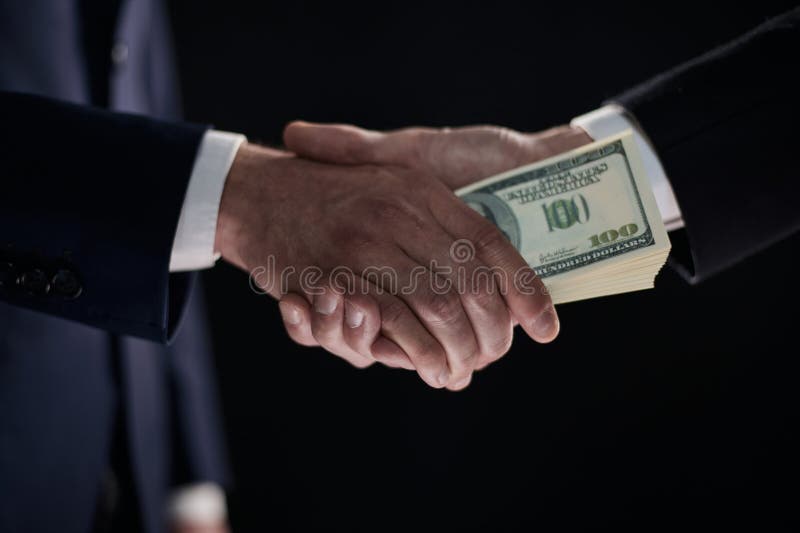 Handshake with the Transfer of Money on a Black Background Stock Image ...